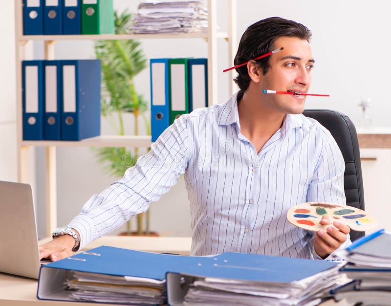 Young Handsome Employee Enjoying Painting at the Office Stock Photo ...