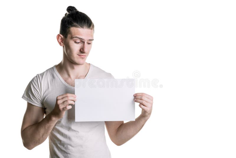 A Young Handsome Guy with a Blank Sheet of Paper Looking at a Sheet ...