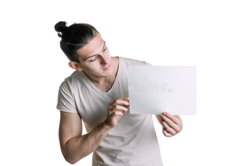 A Young Handsome Guy with a Blank Sheet of Paper Looking at a Sheet ...