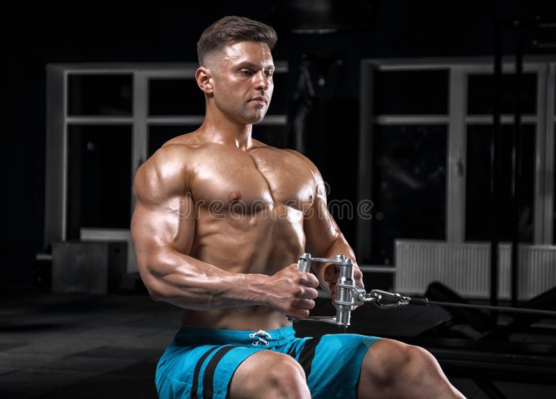 Young Handsome Guy Doing Exercises in the Gym Stock Photo - Image of ...