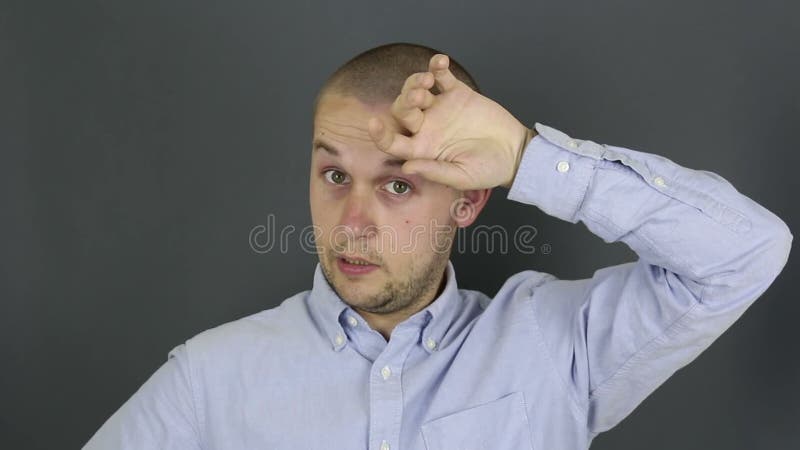 A Young Handsome Guy Rubs His Forehead With His Hand From Fatigue A