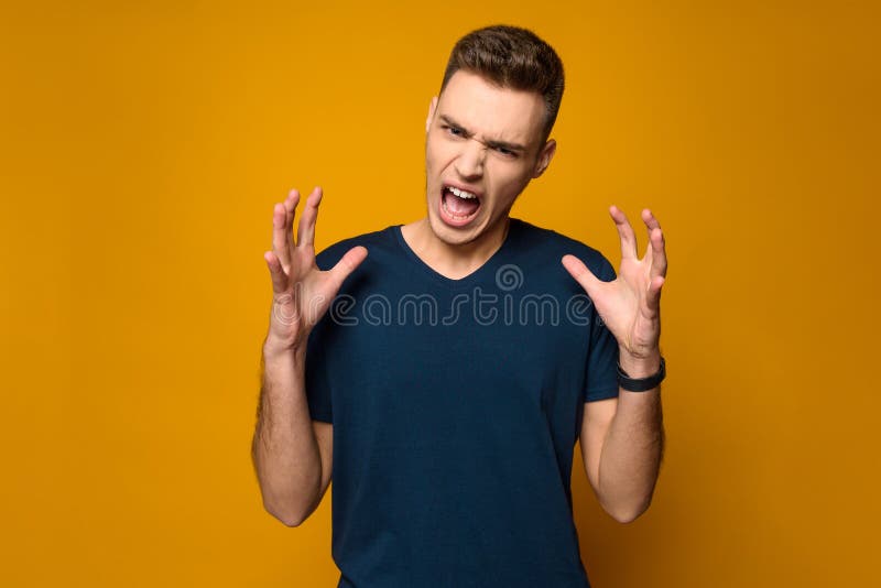 A Young Man Shouts with His Hands Cupped Like a Megaphone Stock Photo ...