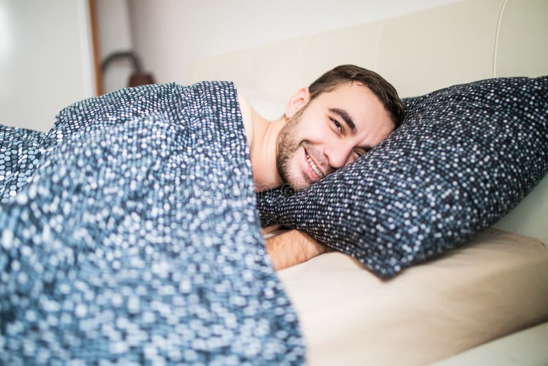Young Handsome Happy Man Waking Up on Bed at Home Stock Photo - Image ...