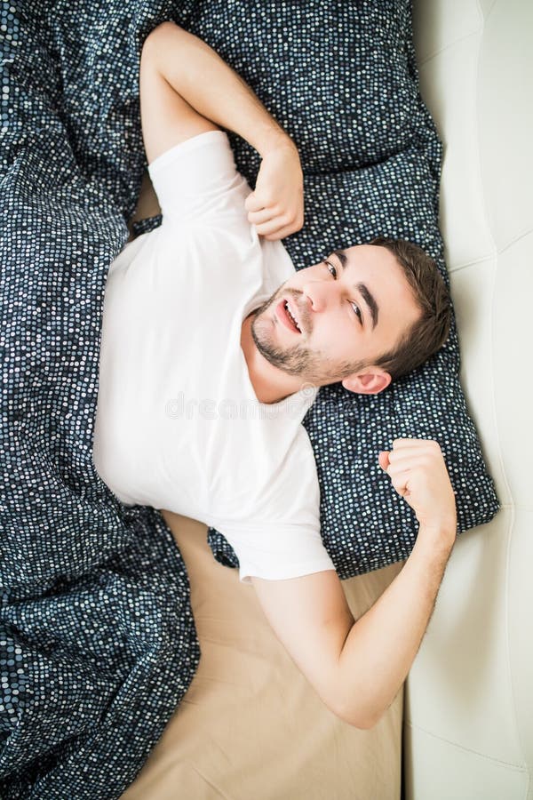 Young Handsome Happy Man Waking Up on Bed at Home, Top View Stock Photo ...