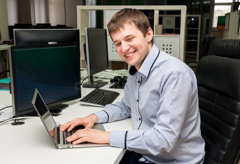 Young Handsome Laughing Man with Computer in the Office Stock Photo ...