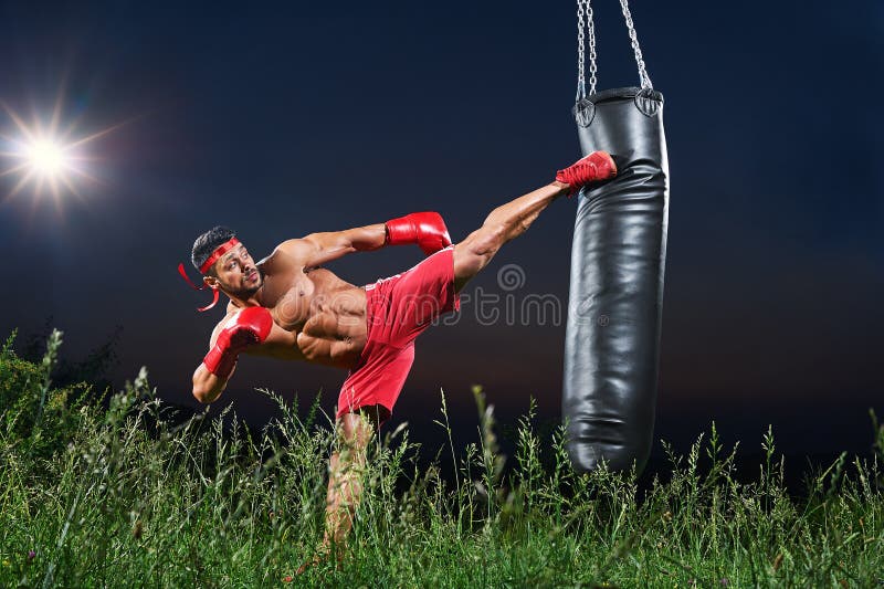 Young Handsome Male Boxer Practicing on a Punching Bag Outdoors Stock ...