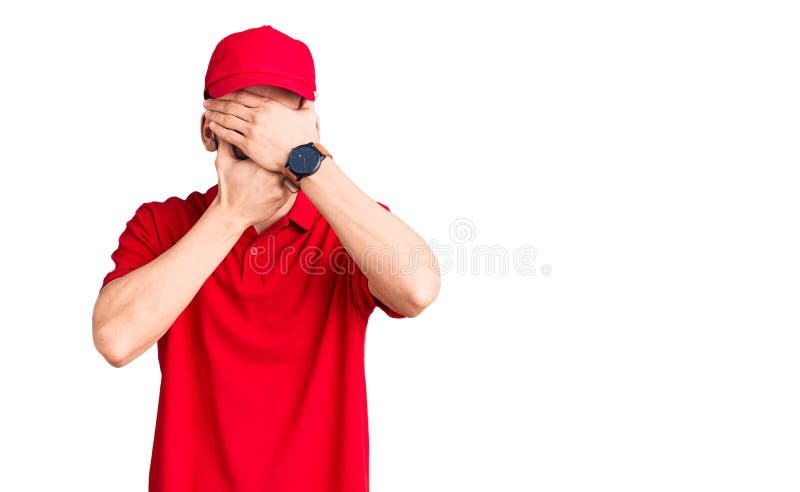 Young Handsome Man With Beard Wearing Delivery Uniform Covering Eyes