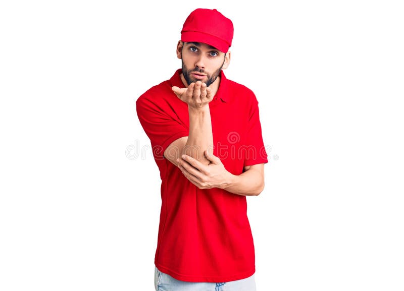 Young Handsome Man With Beard Wearing Delivery Uniform Looking At The