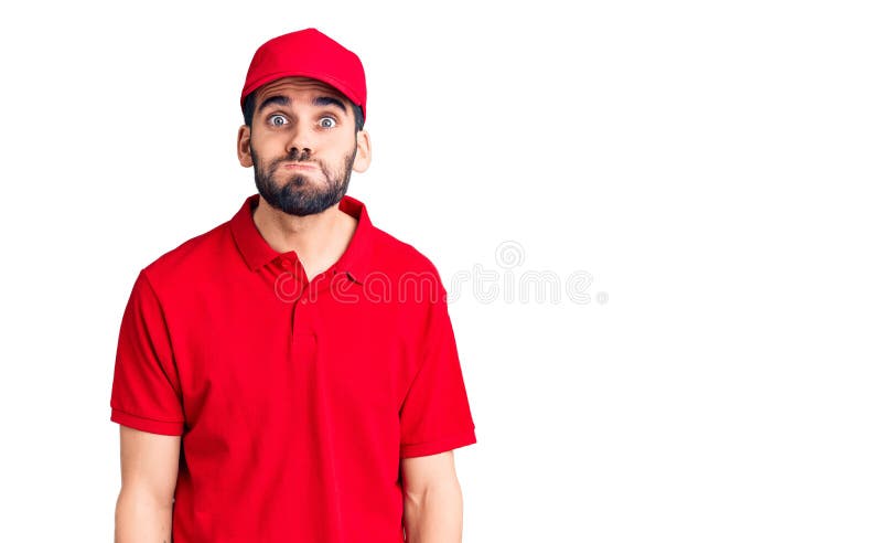 Young Handsome Man With Beard Wearing Delivery Uniform Puffing Cheeks