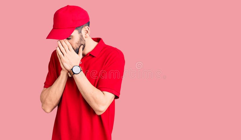 Young Handsome Man With Beard Wearing Delivery Uniform With Sad