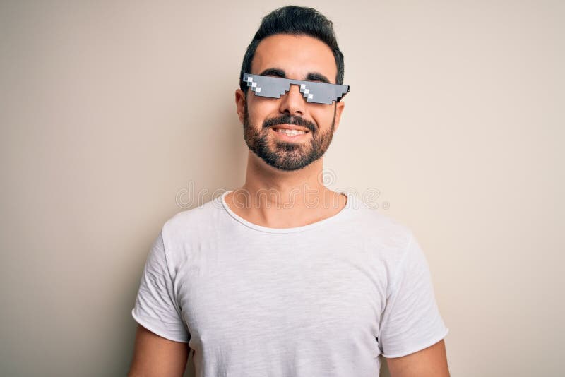 Young Handsome Man With Beard Wearing Funny Thug Life Sunglasses Over