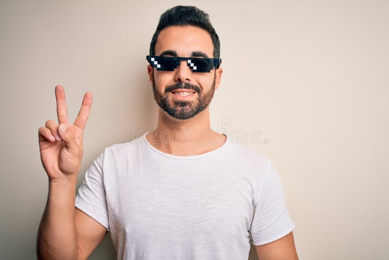 Young Handsome Man With Beard Wearing Funny Thug Life Sunglasses Over