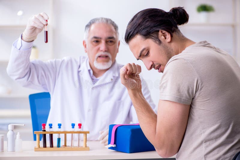 The Young Handsome Man during Blood Test Sampling Procedure Stock Photo ...