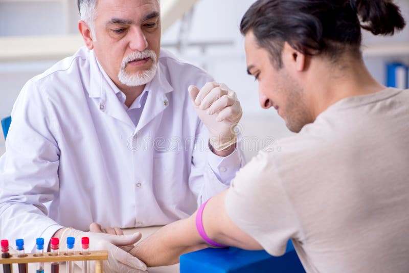 Young Handsome Man during Blood Test Sampling Procedure Stock Photo ...