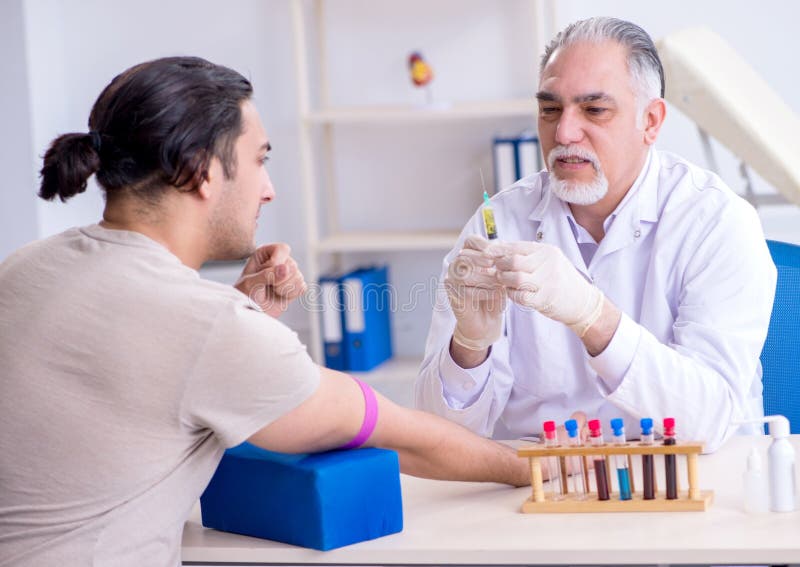 Young Handsome Man during Blood Test Sampling Procedure Stock Photo ...