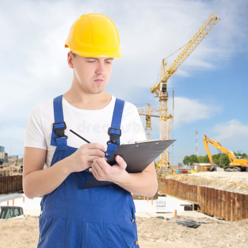 Young Handsome Man in Builder Uniform with Clipboard at Constru Stock ...