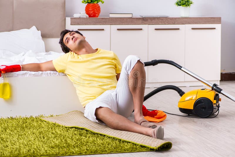 The Young Handsome Man Cleaning in the Bedroom Stock Photo - Image of ...