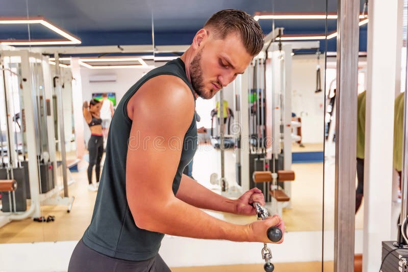 Young Handsome Man Does Lat Pull Up Exercise in Gym Stock Image - Image ...