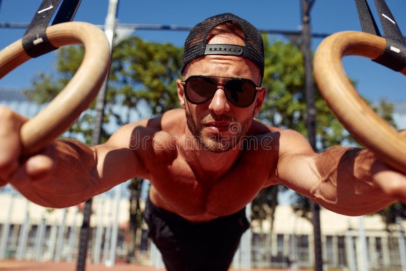 Young and Handsome Man is Doing Some Push-ups. he is Using Loops for ...