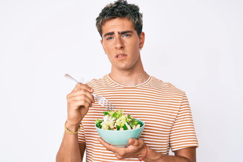 Young Handsome Man Eating Salad Clueless and Confused Expression Stock ...