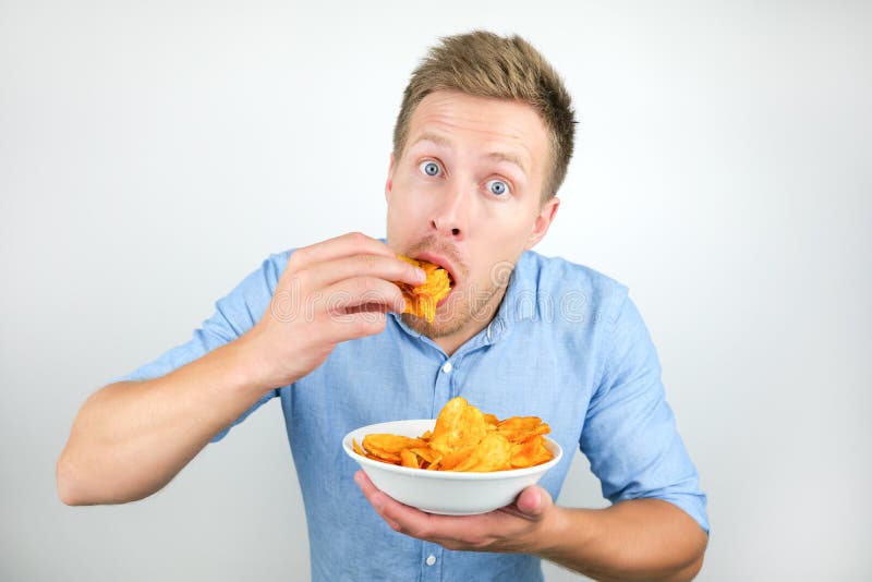 The guy eats chips stock image. Image of sustenance, male - 17488343