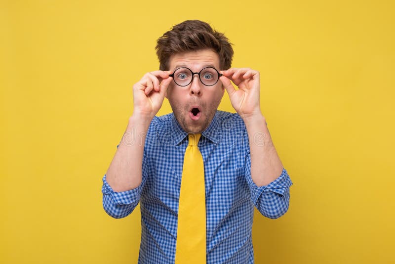 Young Handsome Man With Glasses Is Shocked Surprise And Amazed