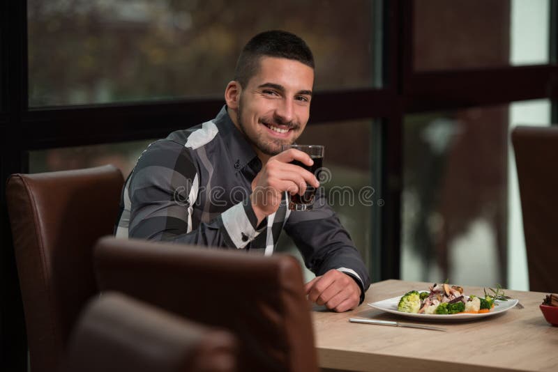 Young Handsome Man Having Dinner in a Restaurant Stock Photo - Image of ...