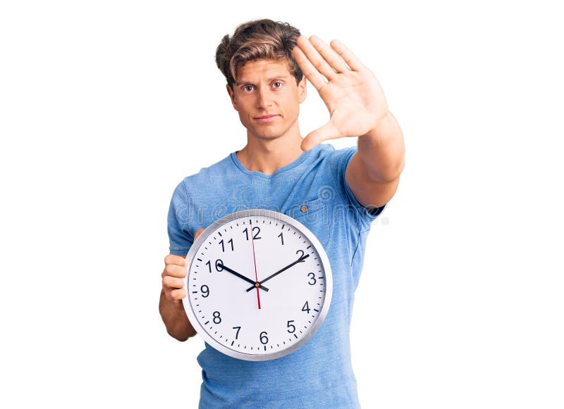 Young Handsome Man Holding Big Clock with Open Hand Doing Stop Sign ...