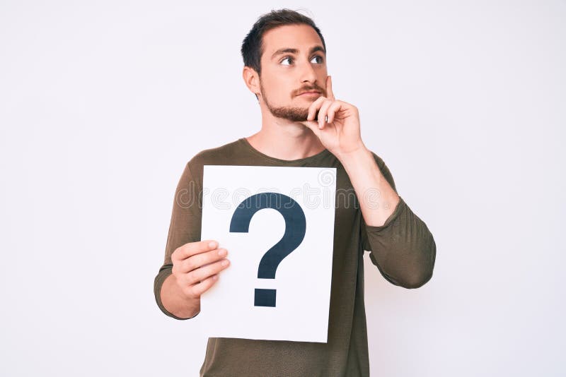 Young Handsome Man Holding Question Mark Serious Face Thinking about ...