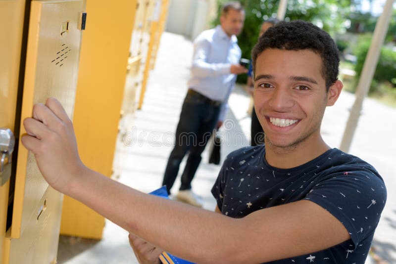Young Handsome Man Opening Metal Locker Door Stock Image - Image of ...