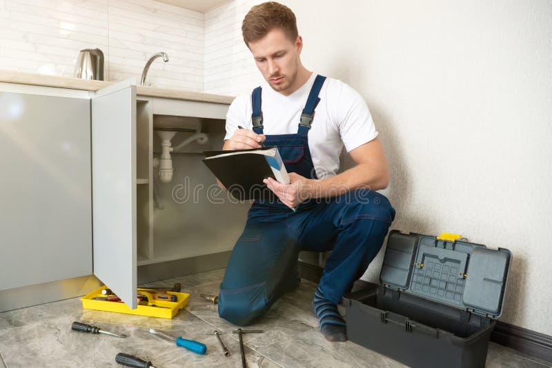 Young Handsome Man Plumber Looks Concentrated while Checking ...