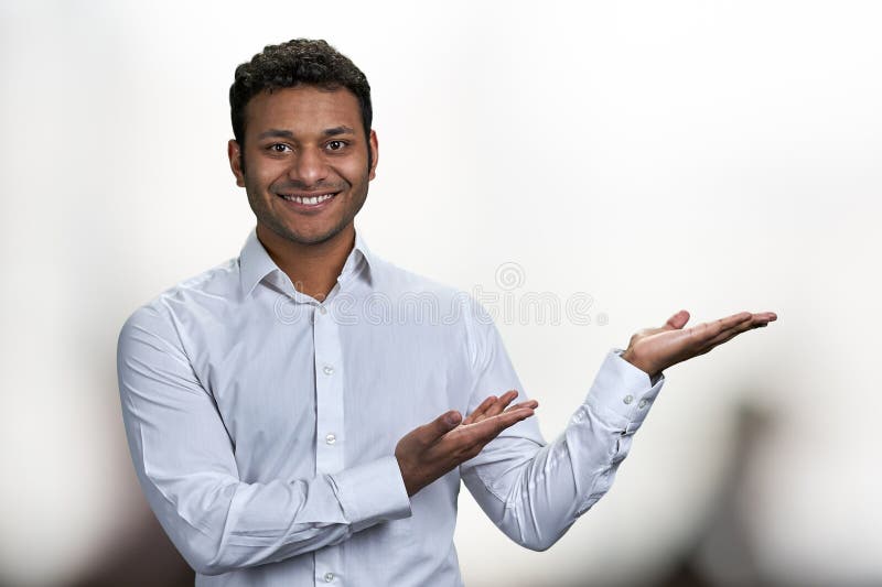 Young Handsome Man Pointing To the Side with Hand and Open Palm ...