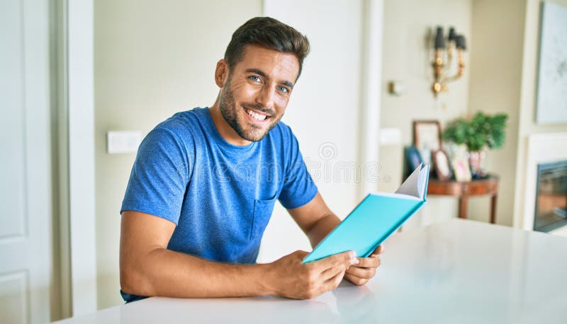 Young Handsome Man Smiling Happy Reading Book at Home Stock Image ...