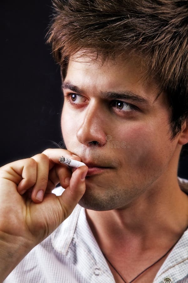 Young handsome man smoking stock photo. Image of alone - 11880722