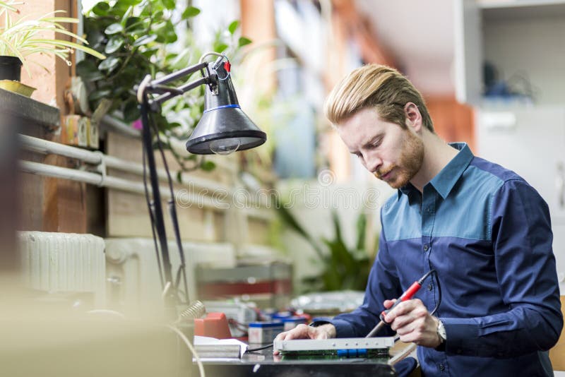 Young Handsome Man Soldering a Circuit Board Stock Photo - Image of ...