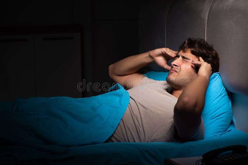 The Young Handsome Man Suffering from Insomnia in Bed Stock Photo ...