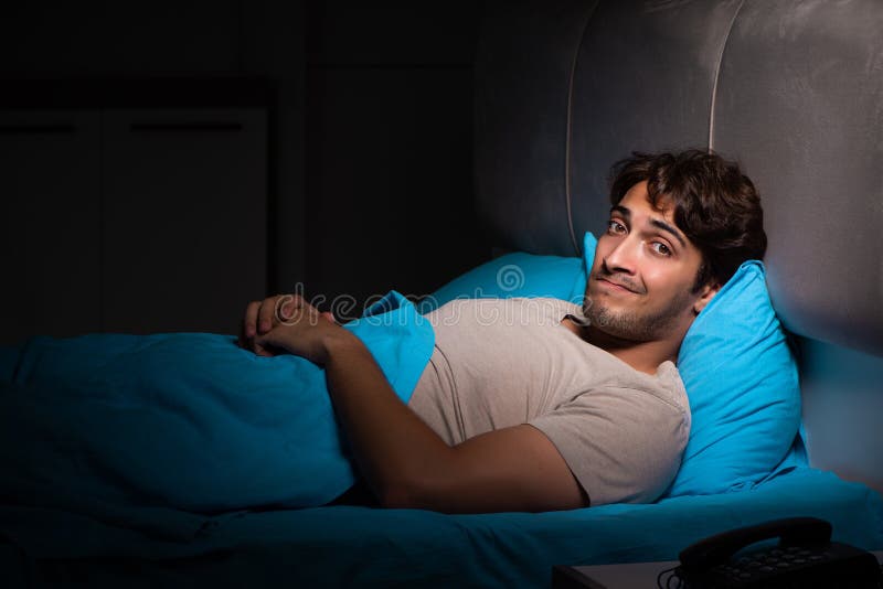 The Young Handsome Man Suffering from Insomnia in Bed Stock Image ...