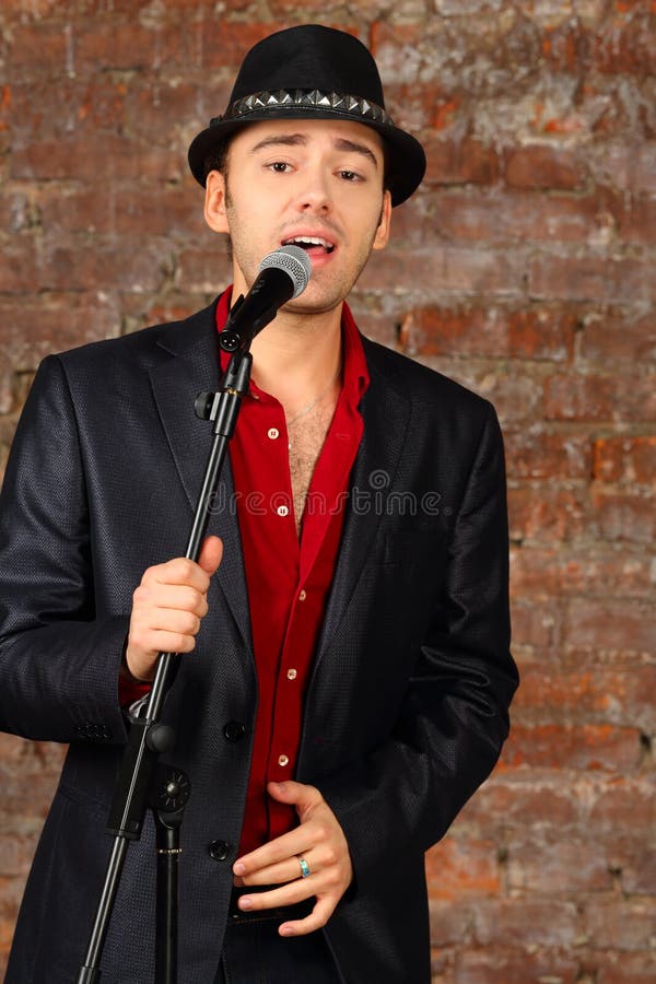 Young Handsome Man in Suit and Hat Sings into Stock Photo - Image of ...