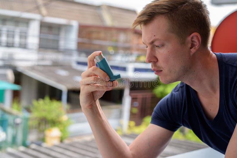 Young Handsome Man Using Asthma Inhaler at Home Stock Image - Image of ...