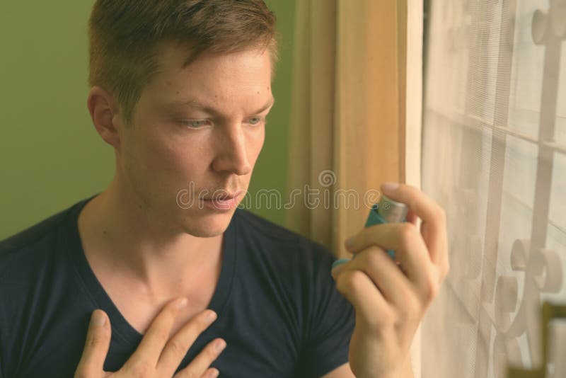 Young Handsome Man Using Asthma Inhaler at Home Stock Image - Image of ...