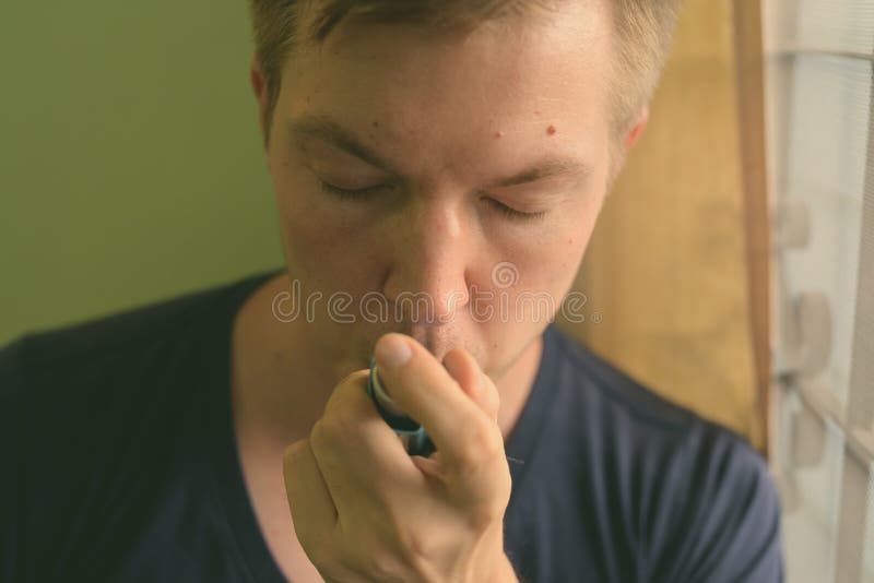 Young Handsome Man Using Asthma Inhaler at Home Stock Photo - Image of ...