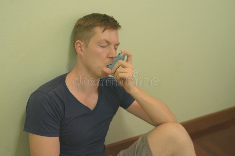 Young Handsome Man Using Asthma Inhaler at Home Stock Photo - Image of ...