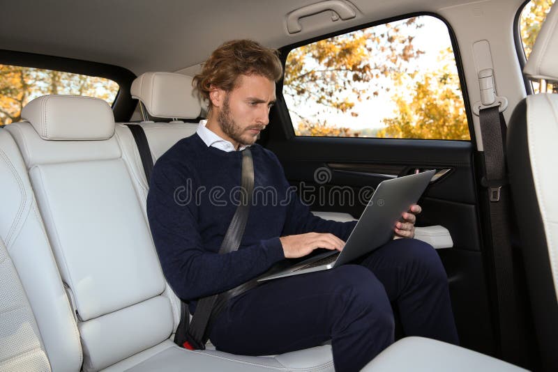 Young Handsome Man Using Laptop in Back Seat Stock Image - Image of ...