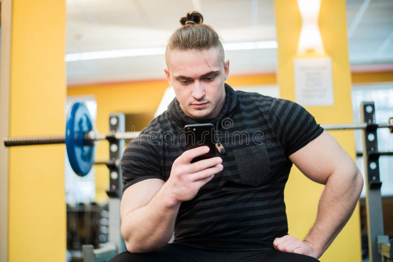 Young Handsome Man Using Phone while Having Exercise Break in Gym ...
