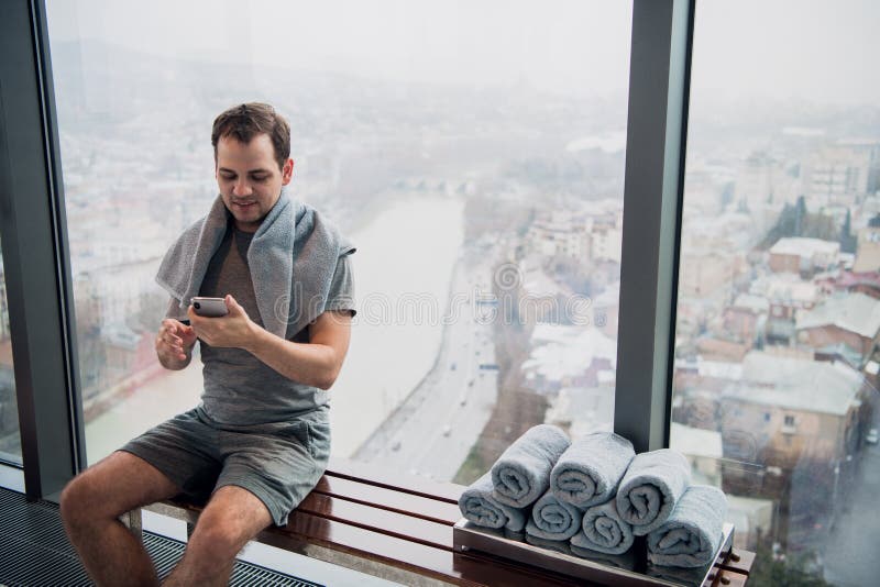 Young Handsome Man Using Phone while Having Exercise Break in Gym Stock ...