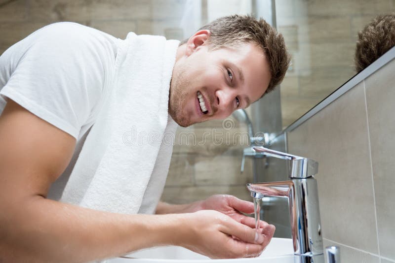 Young Handsome Man Washes His Face in Bathroom Stock Photo - Image of ...