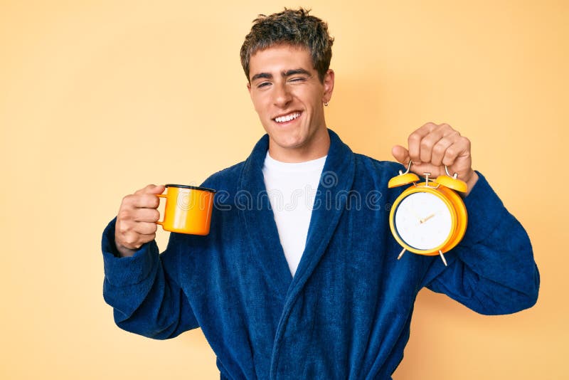 Young Handsome Man Wearing Bathrobe Holding Cup of Coffee and Alarm ...