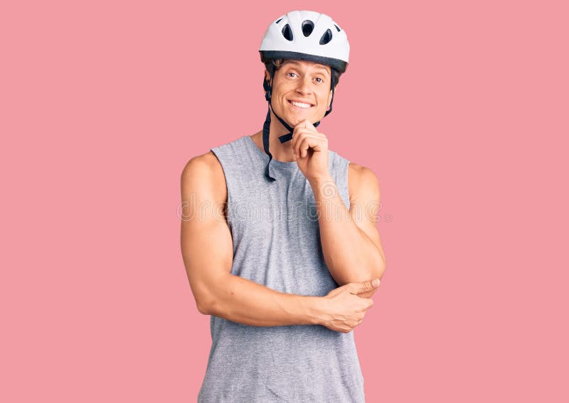 Young Handsome Man Wearing Bike Helmet Looking Confident At The Camera