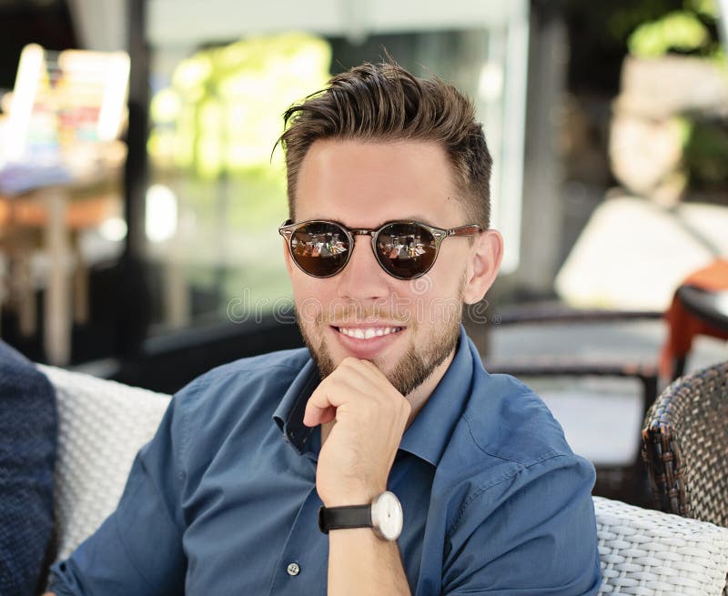 Young Handsome Man Wearing Sunglasses and Blue Shirt Smiling Stock ... Young Handsome Man Wearing Sunglasses and Blue Shirt Smiling Stock ...