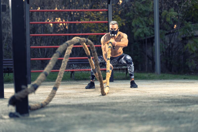 Shirtless Ripped Young Man Doing Pull Ups Outdoors and Showing ...